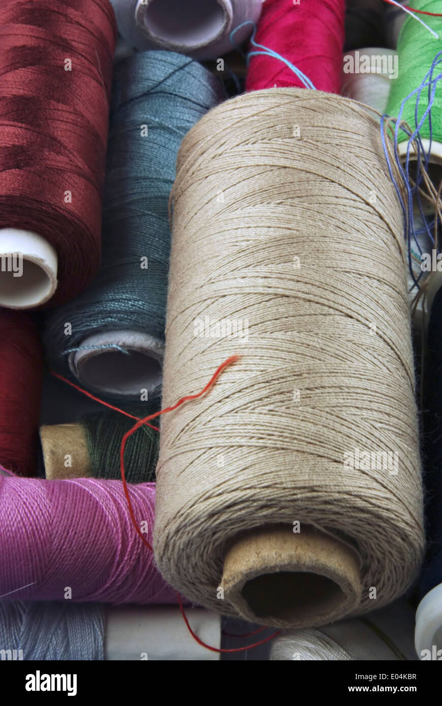 Sewing cotton in different colors, packed and unpacked, in plastic box ...