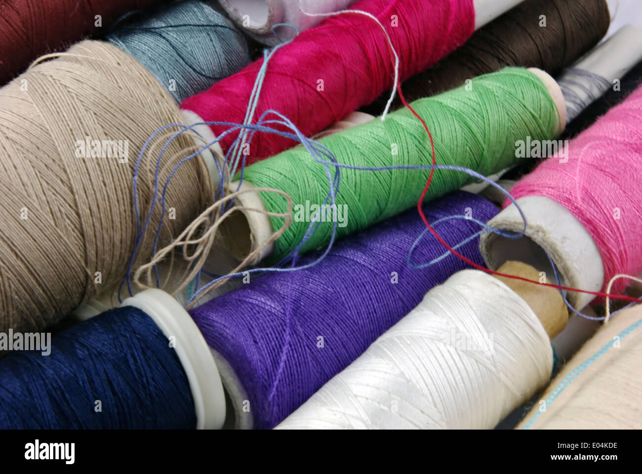 Sewing cotton in different colors, packed and unpacked, in plastic box ...
