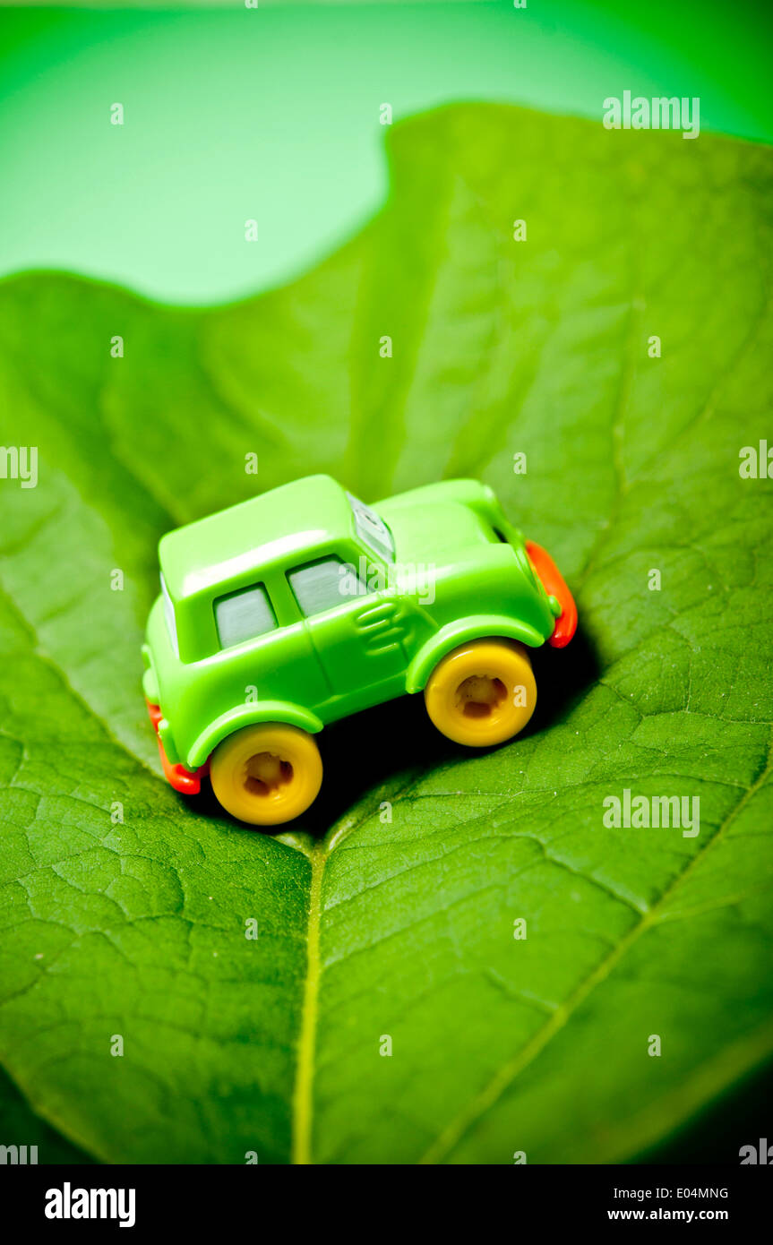 small green toy car on a leaf, green car concept Stock Photo - Alamy