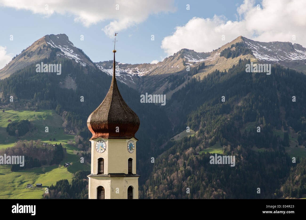church steeple in front of alpine mountains Stock Photo - Alamy