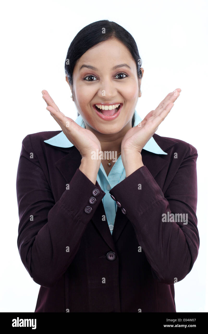 Excited young business woman against white background Stock Photo - Alamy