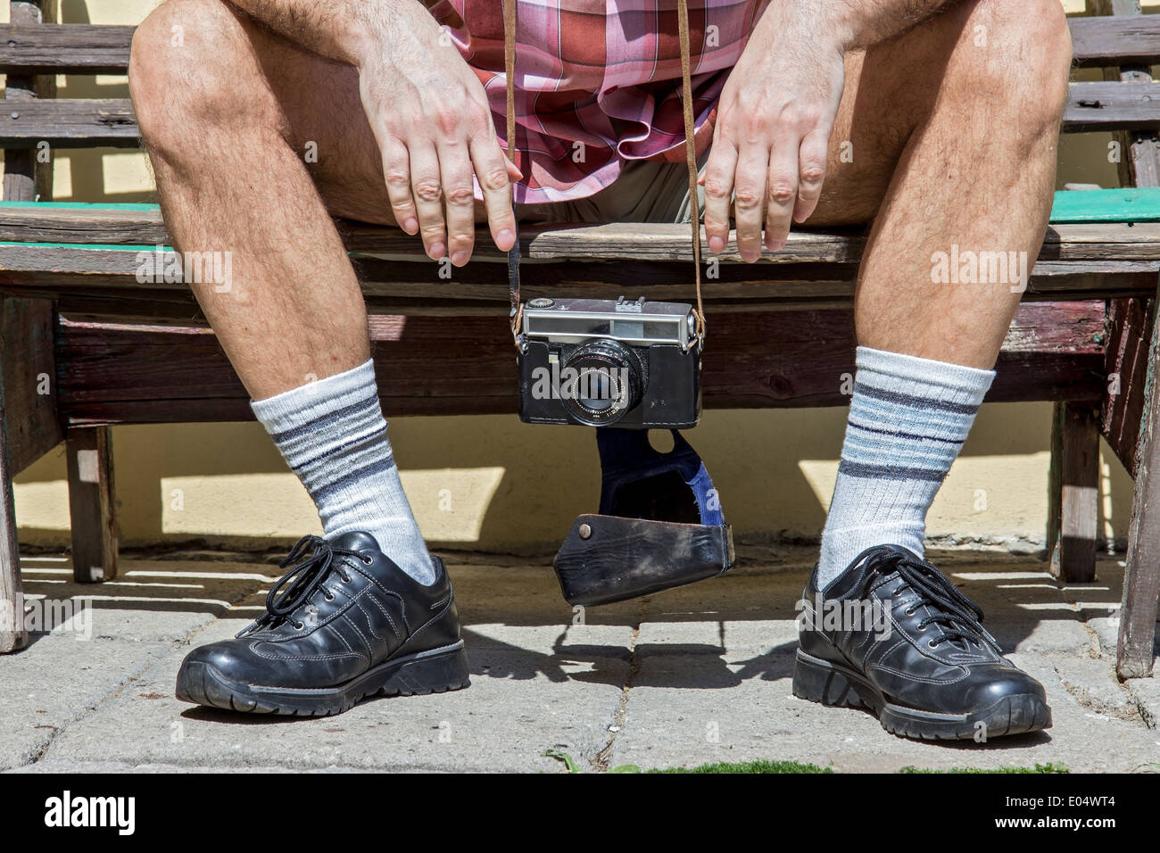 legs of man sitting on a bench Stock Photo - Alamy