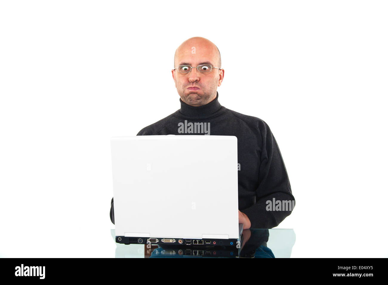 Surprised man blow out his cheeks and looks surprised at the desk with ...