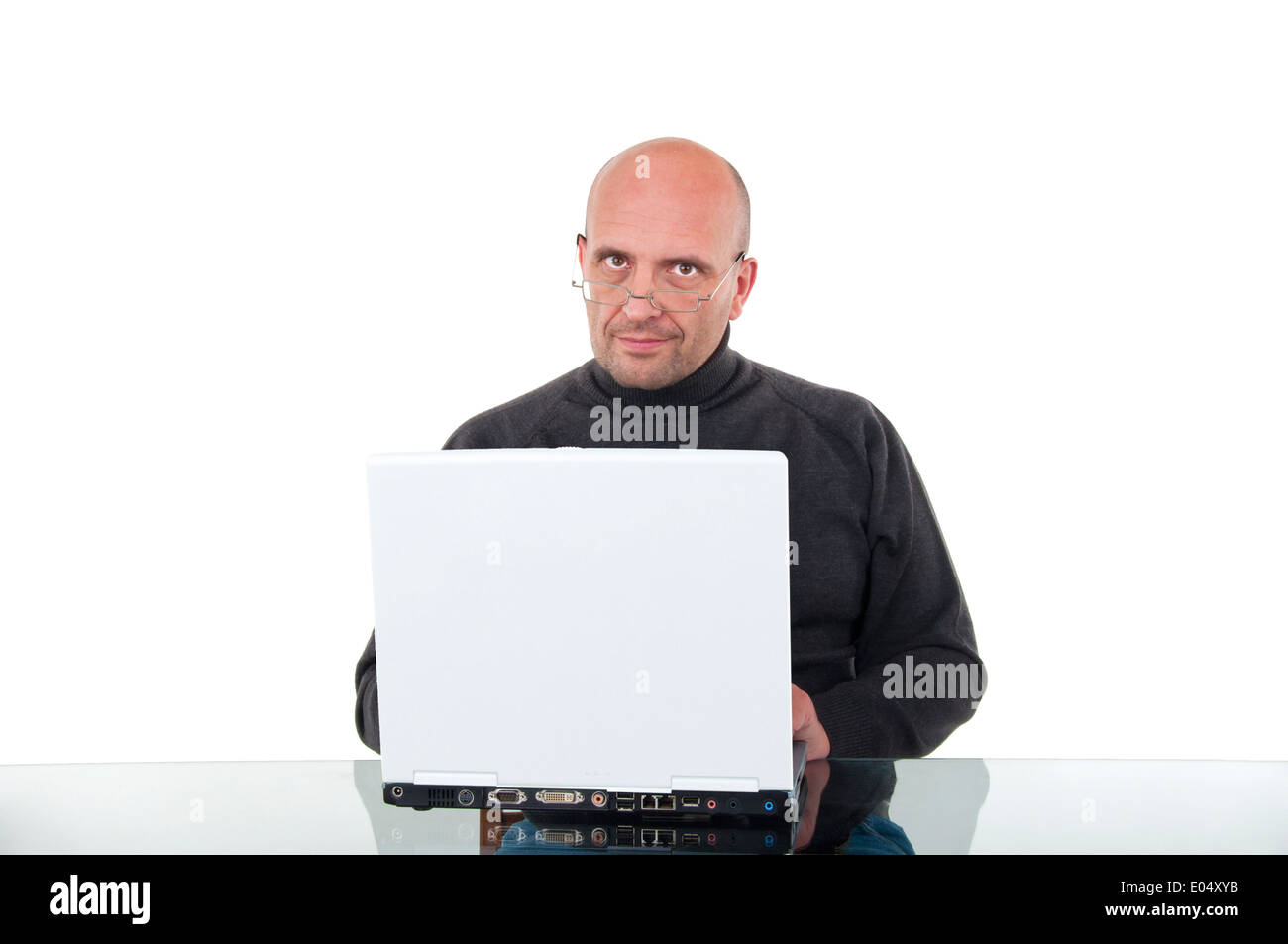 Bald man with reading glasses working with his laptop Stock Photo - Alamy