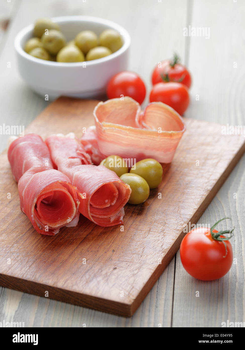 dried jamon slices on wood table, spanish traditional food Stock Photo ...