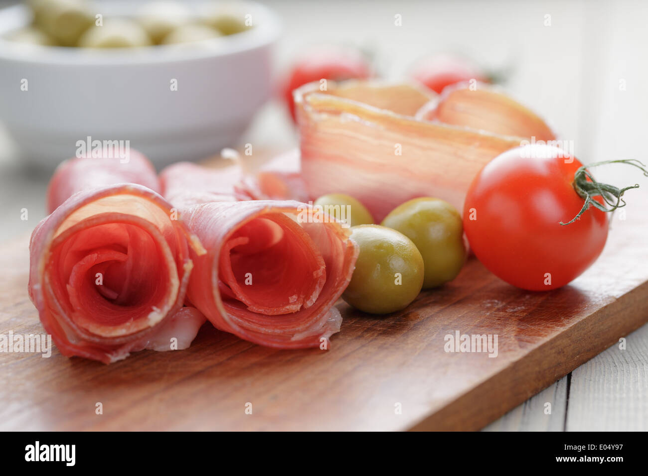 dried jamon slices on wood table, spanish traditional food Stock Photo ...