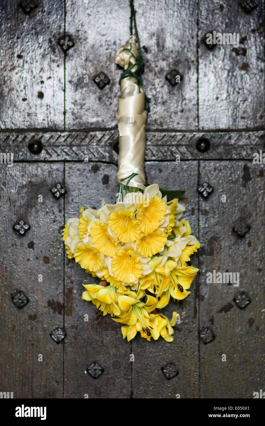 Bouquet of Daffodils Hanging on a church door Stock Photo - Alamy
