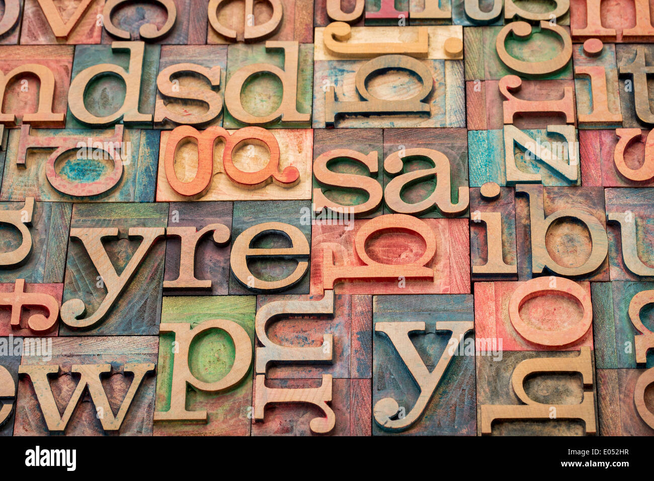 background of letterpress wood type printing blocks stained by color ...