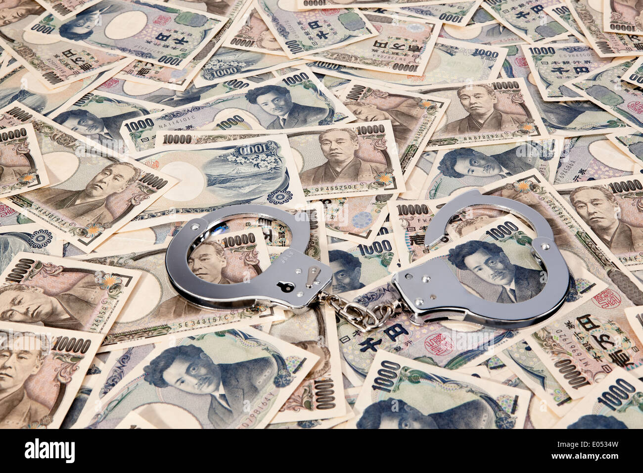 Yen bank notes, currency from Japan with handcuffs. Criminal activity ...