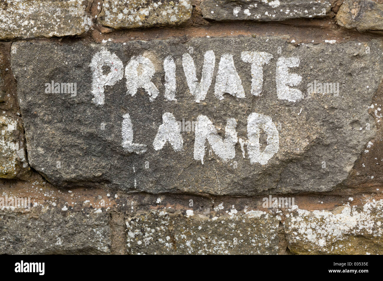 Stone wall with public warning "Private Land Stock Photo - Alamy