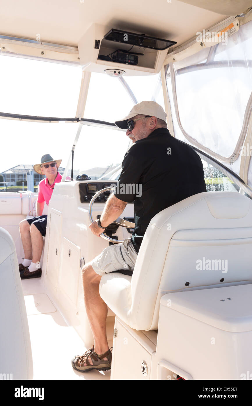 Mature Men Enjoying Cruising in a Motor Boat, Florida, USA Stock Photo ...