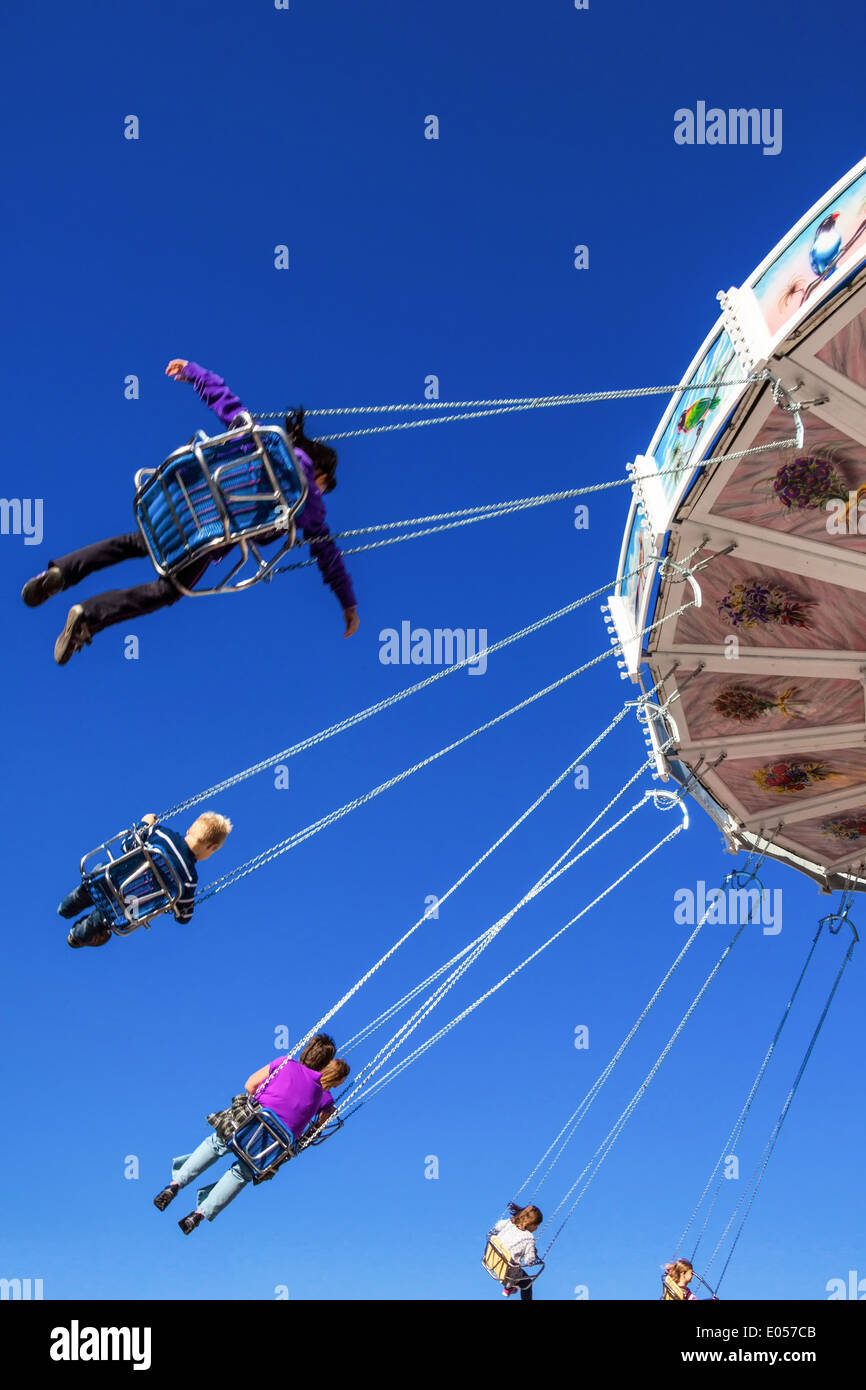 Children on a roundabout at a fun fair hi-res stock photography and ...