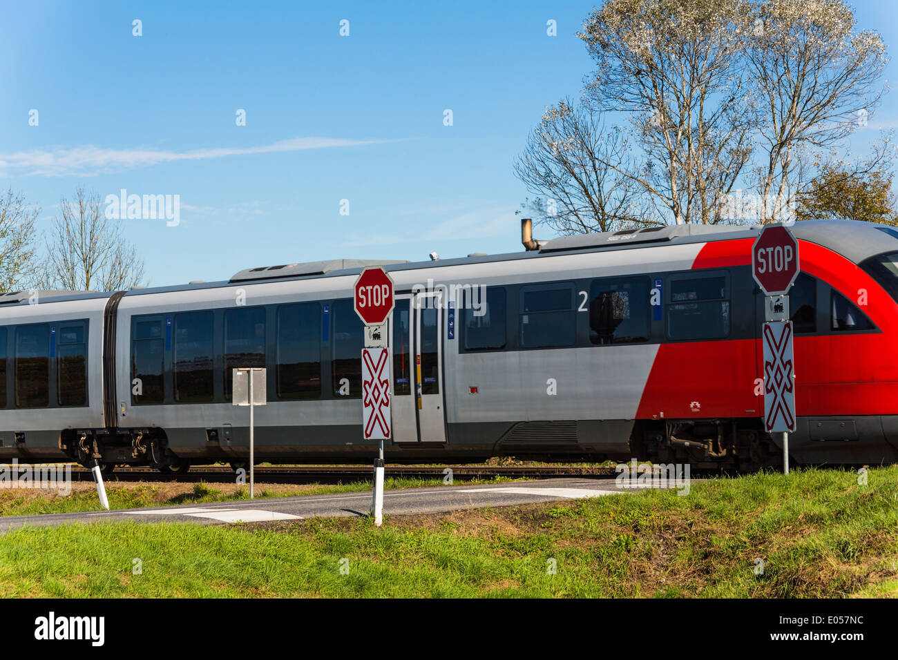 A level crossing of a railway without barriers. Only by traffic sign ...
