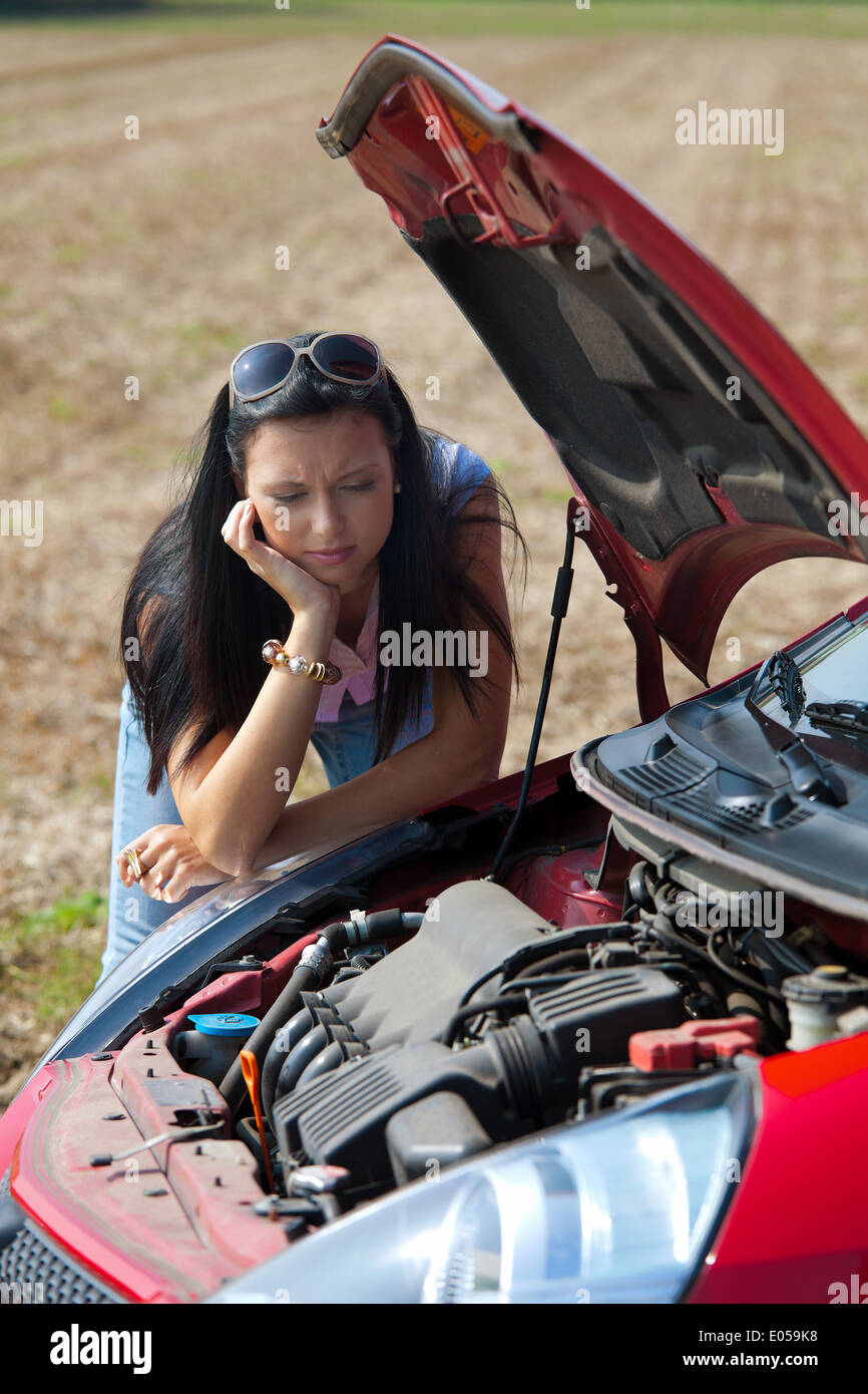 Young woman has a breakdown with her car. Engine trouble, Junge Frau ...