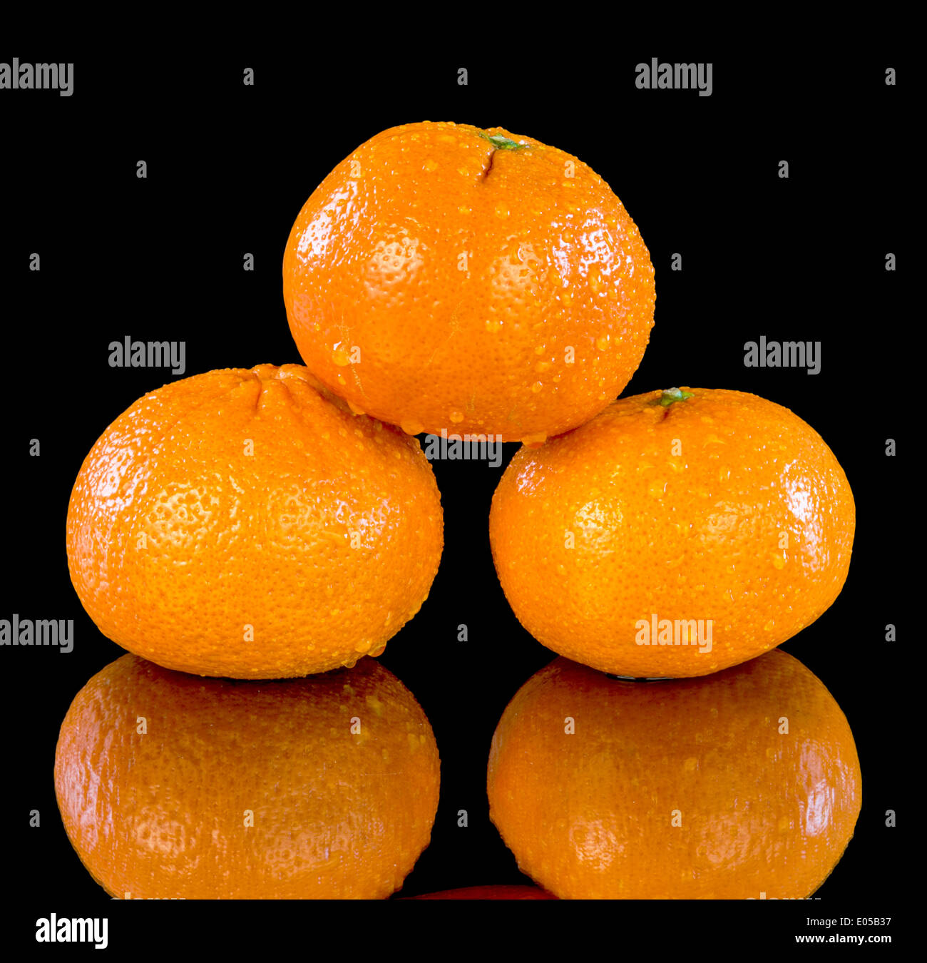Three Tangerines stacked with water on them Stock Photo - Alamy