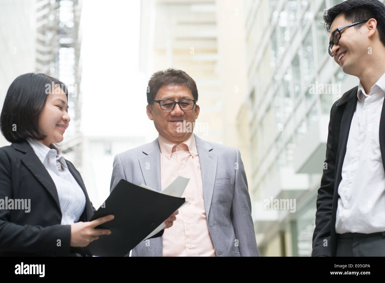 Asian business team meeting. Business executive presenting charts to ...