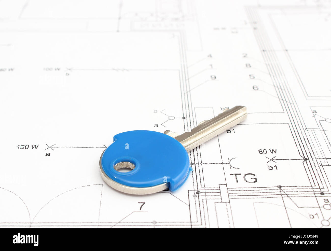 Key lying on construction drawing of house Stock Photo - Alamy