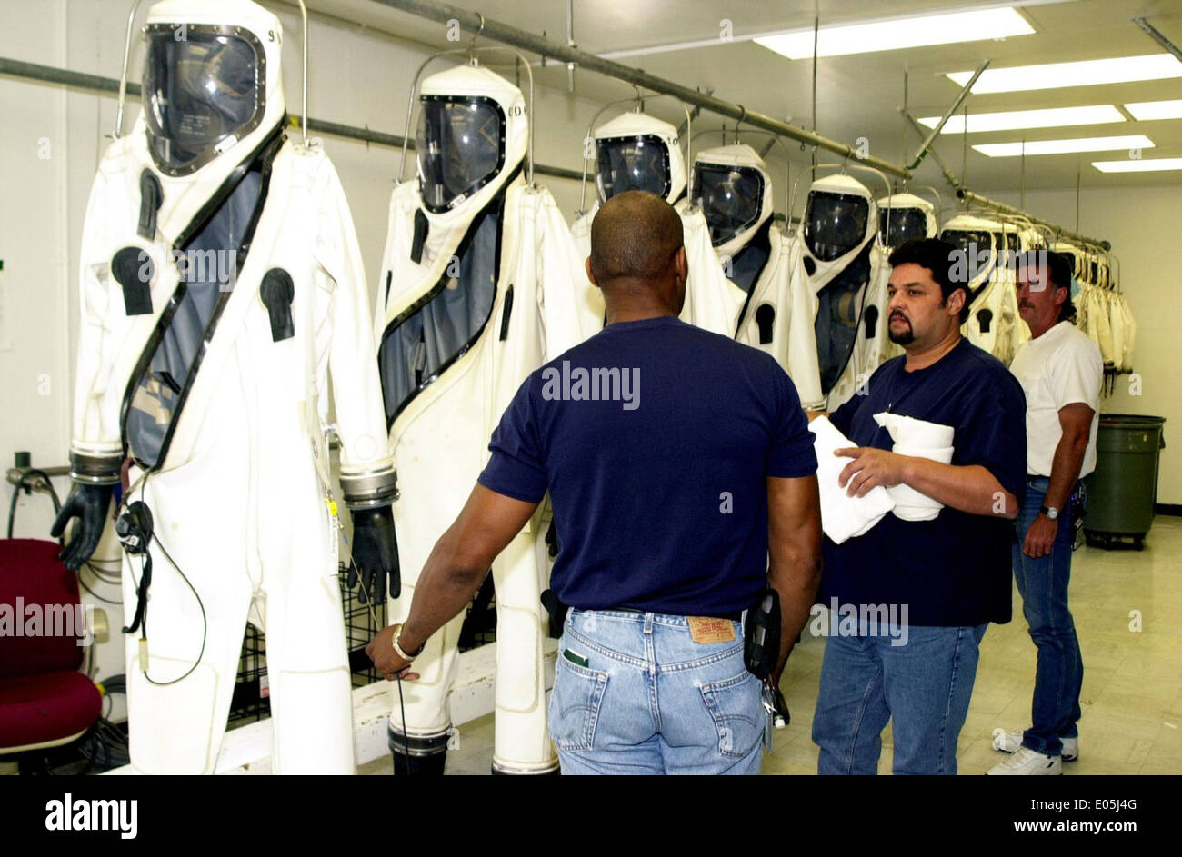 Workers complete preparations by donning SCAPE suits for the fueling ...