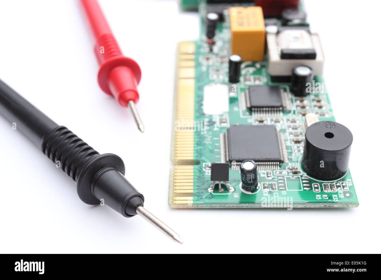 Closeup of cable multimeter and circuit board isolated on white ...