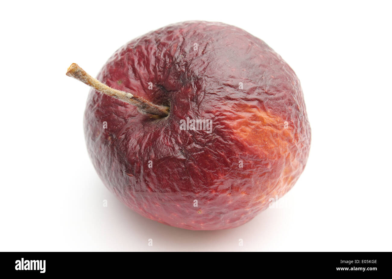 Old and wrinkled apple isolated on white background Stock Photo - Alamy
