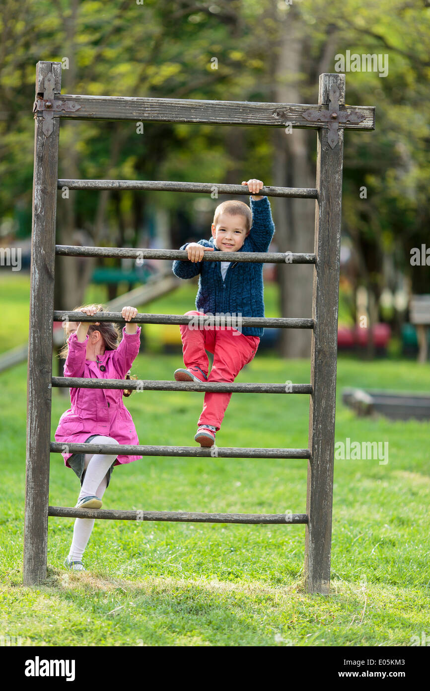 Kids playing at playground Stock Photo - Alamy