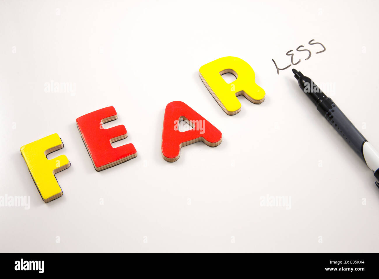 The word FEAR becoming FEARLESS on a whiteboard Stock Photo - Alamy
