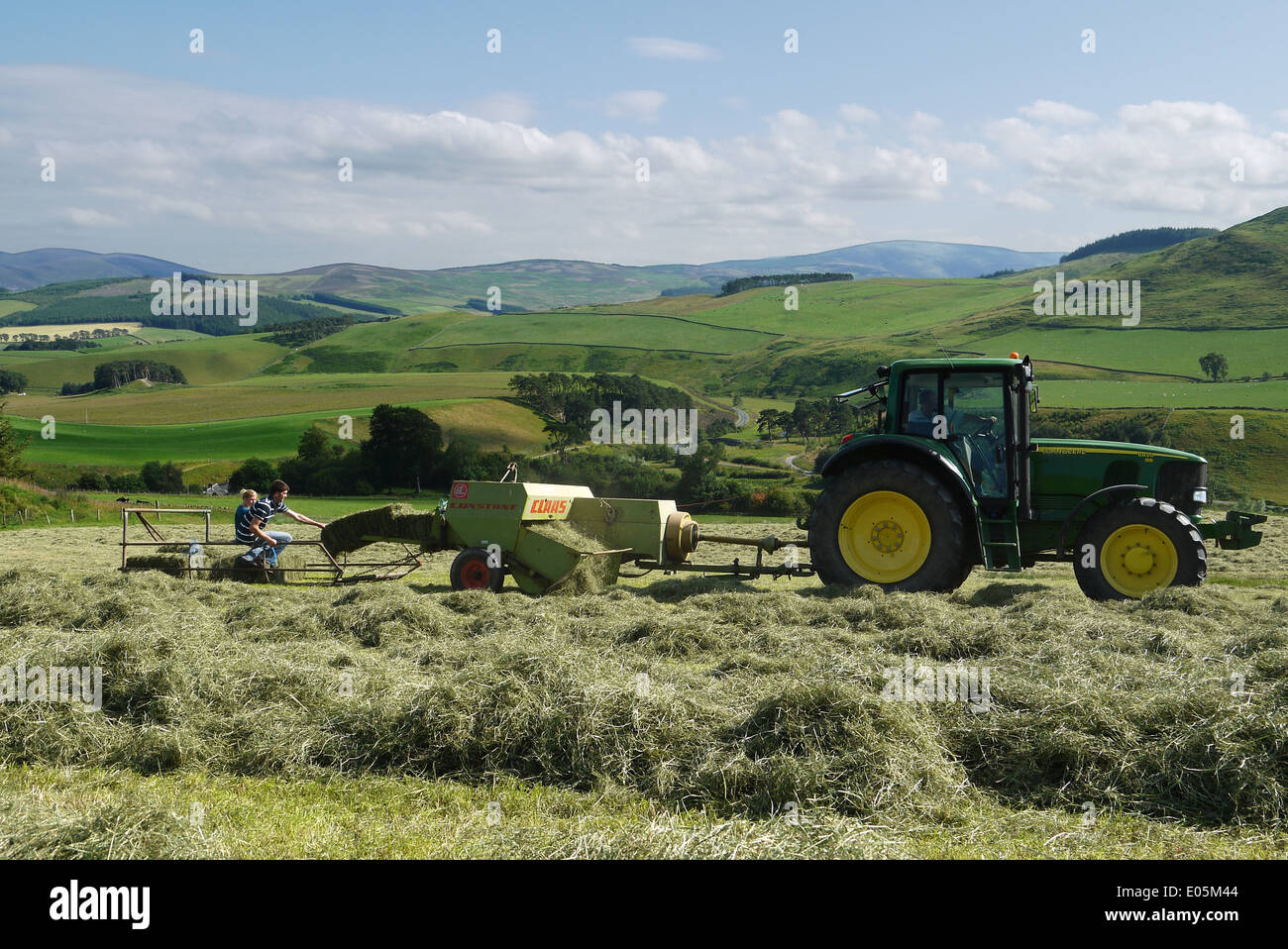 Tractor baling small square bale hay in Peeblesshire Stock Photo - Alamy