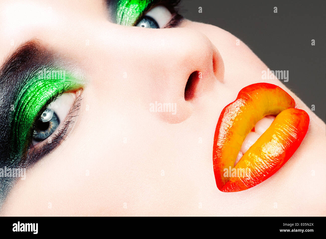 Macro beauty close up of a Caucasian woman's face with acid coloured ...