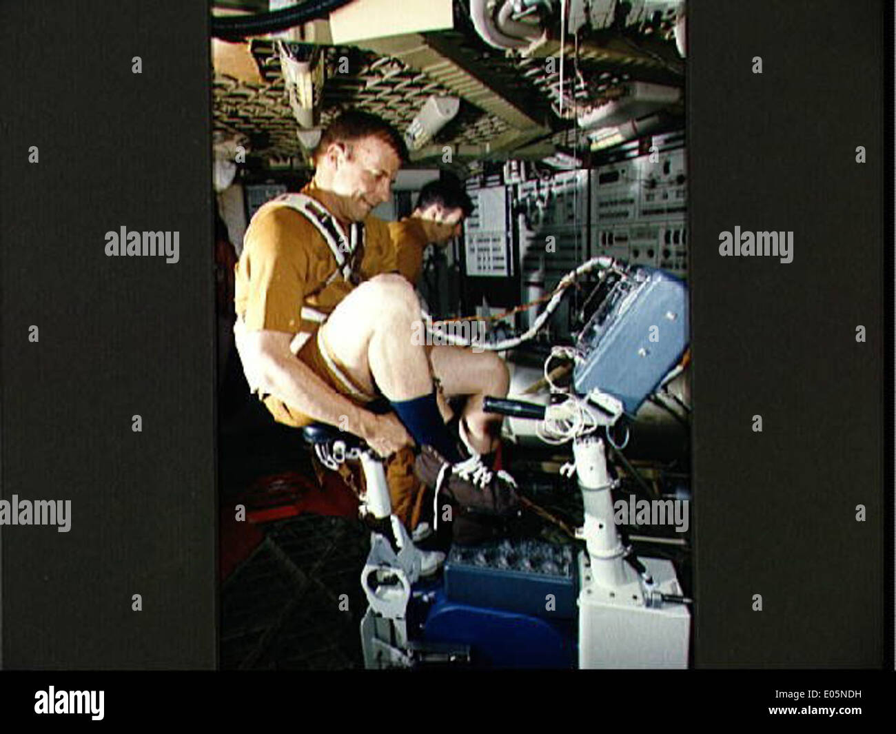 In 1973, NASA Skylab astronauts engage in a cycling exercise aboard the ...
