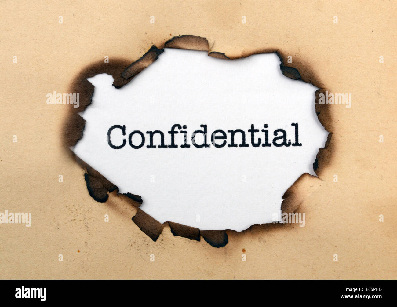 Confidential text in paper hole Stock Photo - Alamy