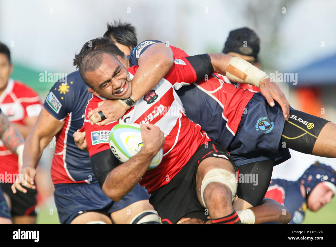 Michael Leitch of Japan is tackled by Justin Coveney of the Philippines ...