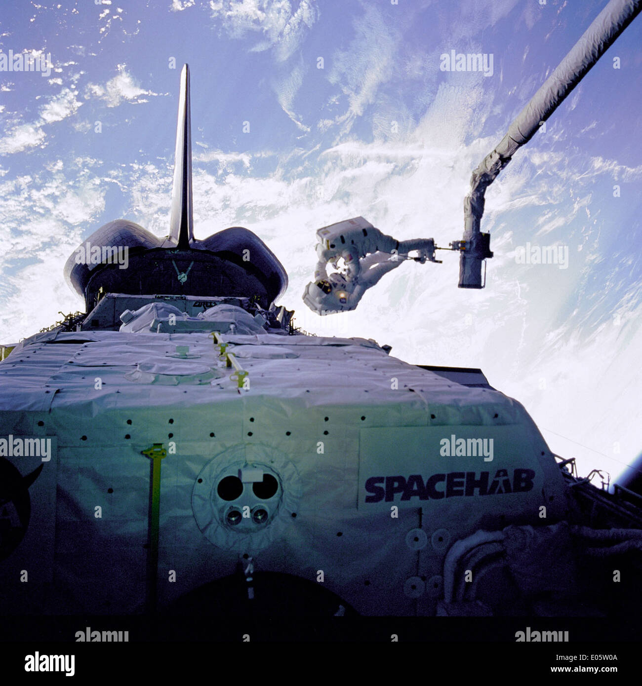 Astronauts G. David Low and Peter Wisoff conduct an extravehicular activity (EVA) on the STS-57 ...