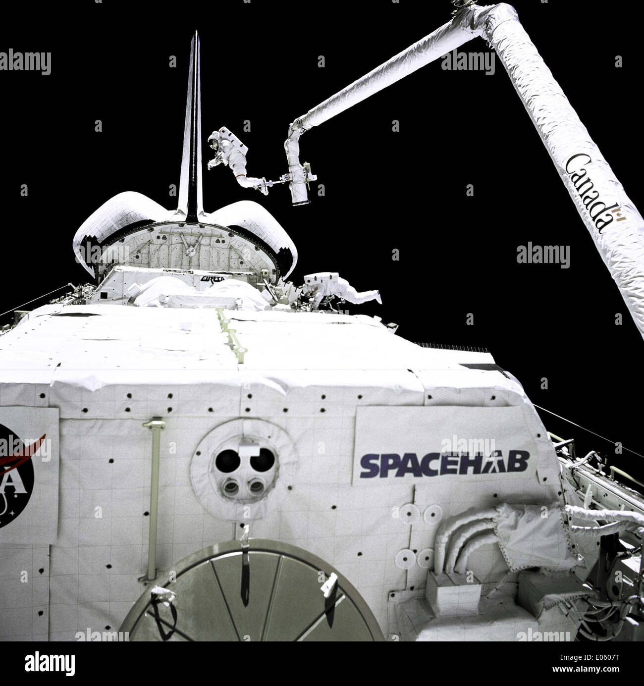 Astronauts David Low and Peter Wisoff perform extravehicular activities ...