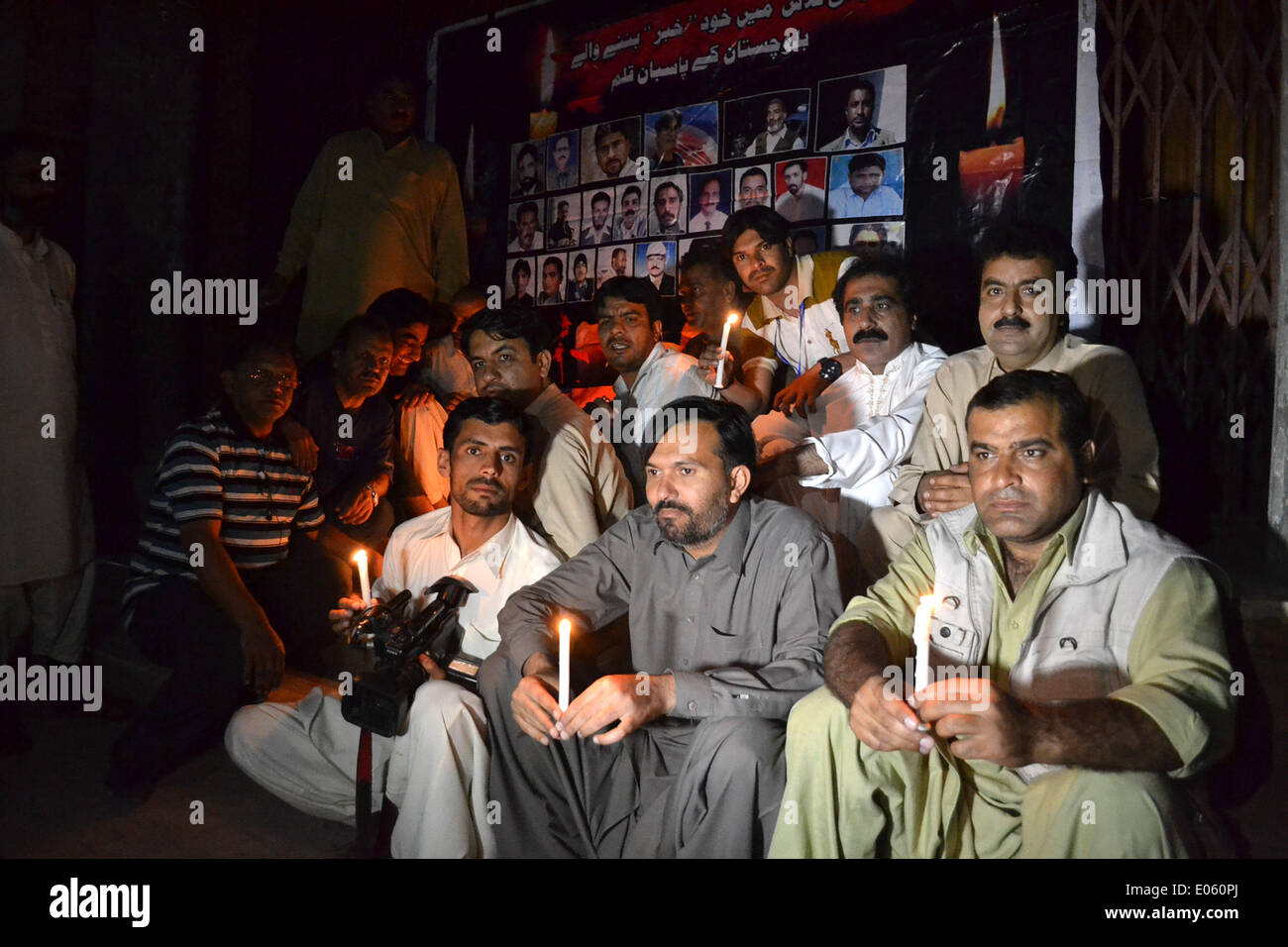 Quetta, Pakistan. 3rd May, 2014. Journalists light candles to mark ...