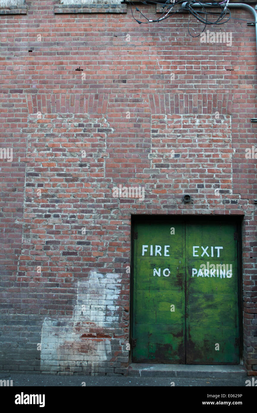 A fire exit doorway in a brick building leading to an alleyway Stock ...