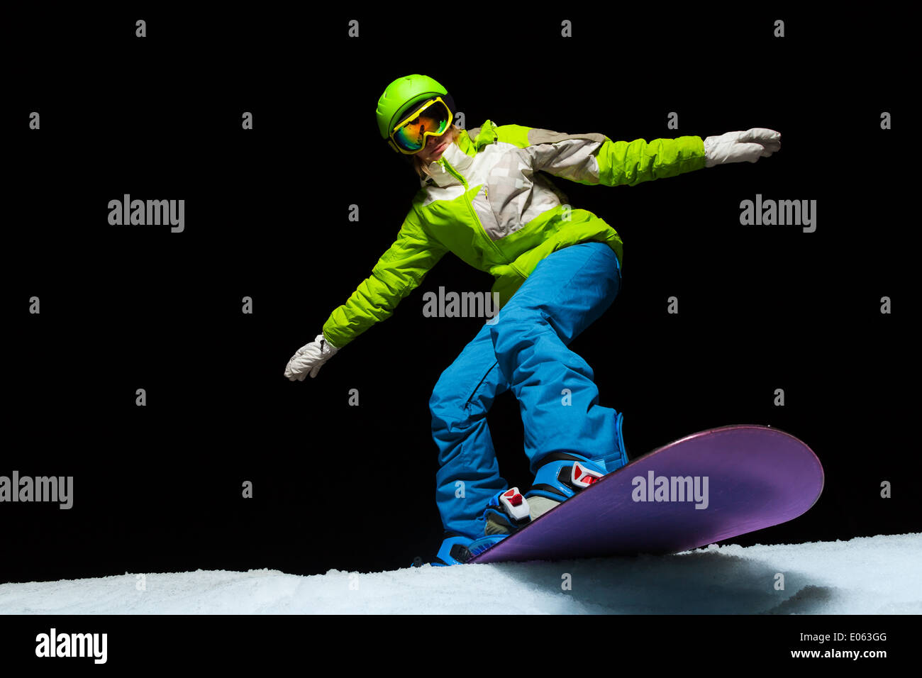 Woman balancing with hands on snowboard Stock Photo - Alamy