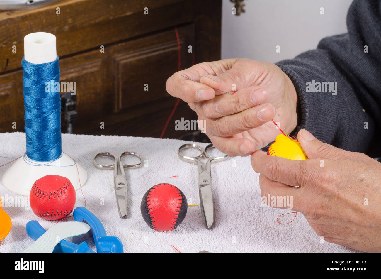 Expert hands crafting traditional sport balls Stock Photo - Alamy