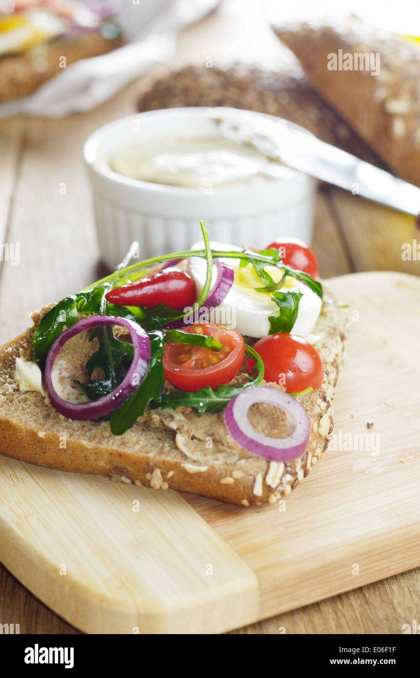 Liver paste sandwich with vegetables arugula and boiled egg on the ...