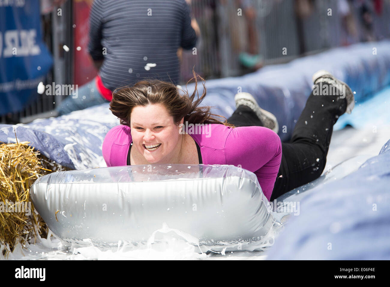 Bristol, UK. 04th May, 2014. People speed down a 90m water slide ...
