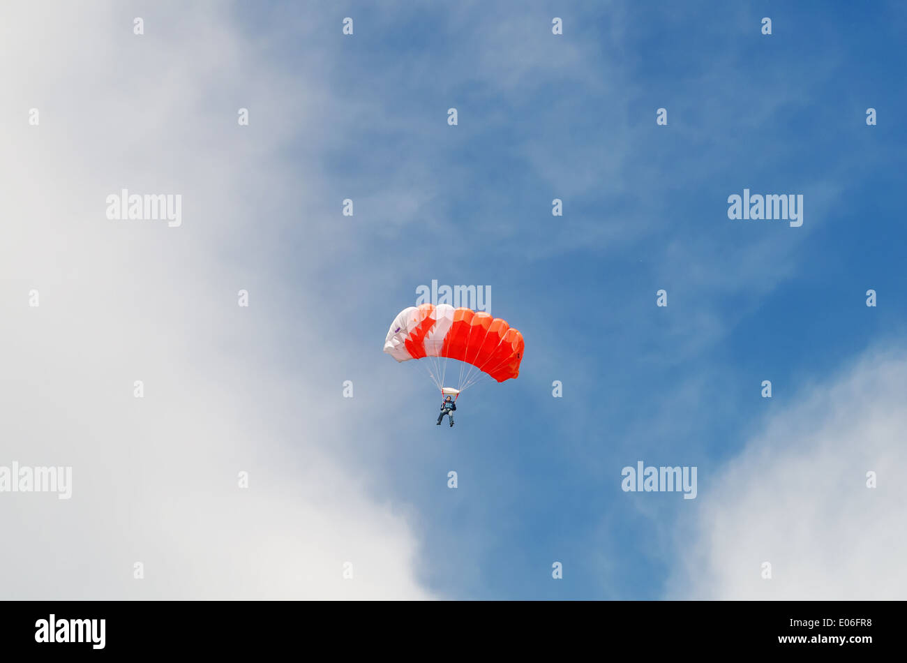 One day with parachutist in airfield. The skydiver lands under the red ...