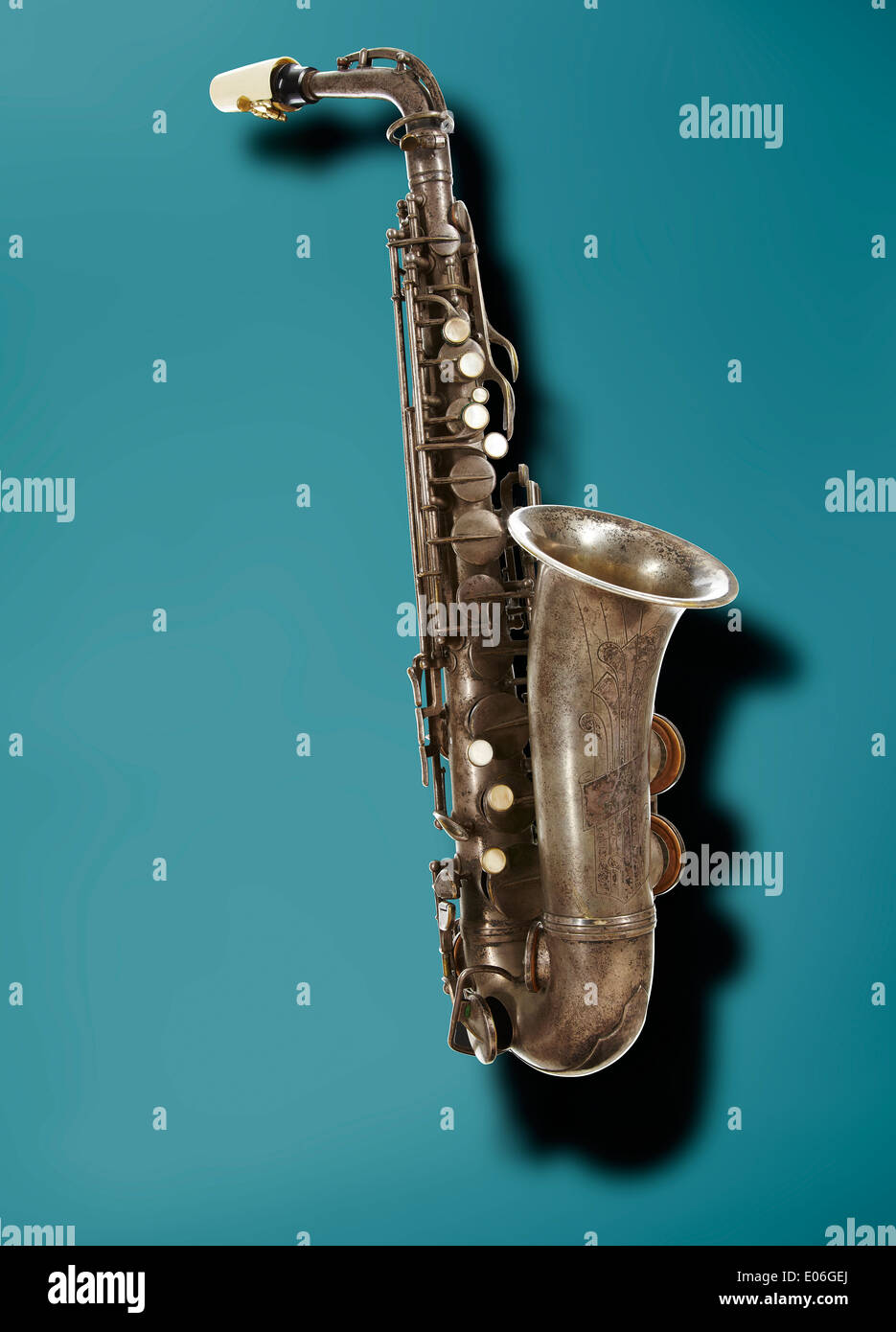 a floating saxophone on a turquoise background Stock Photo - Alamy
