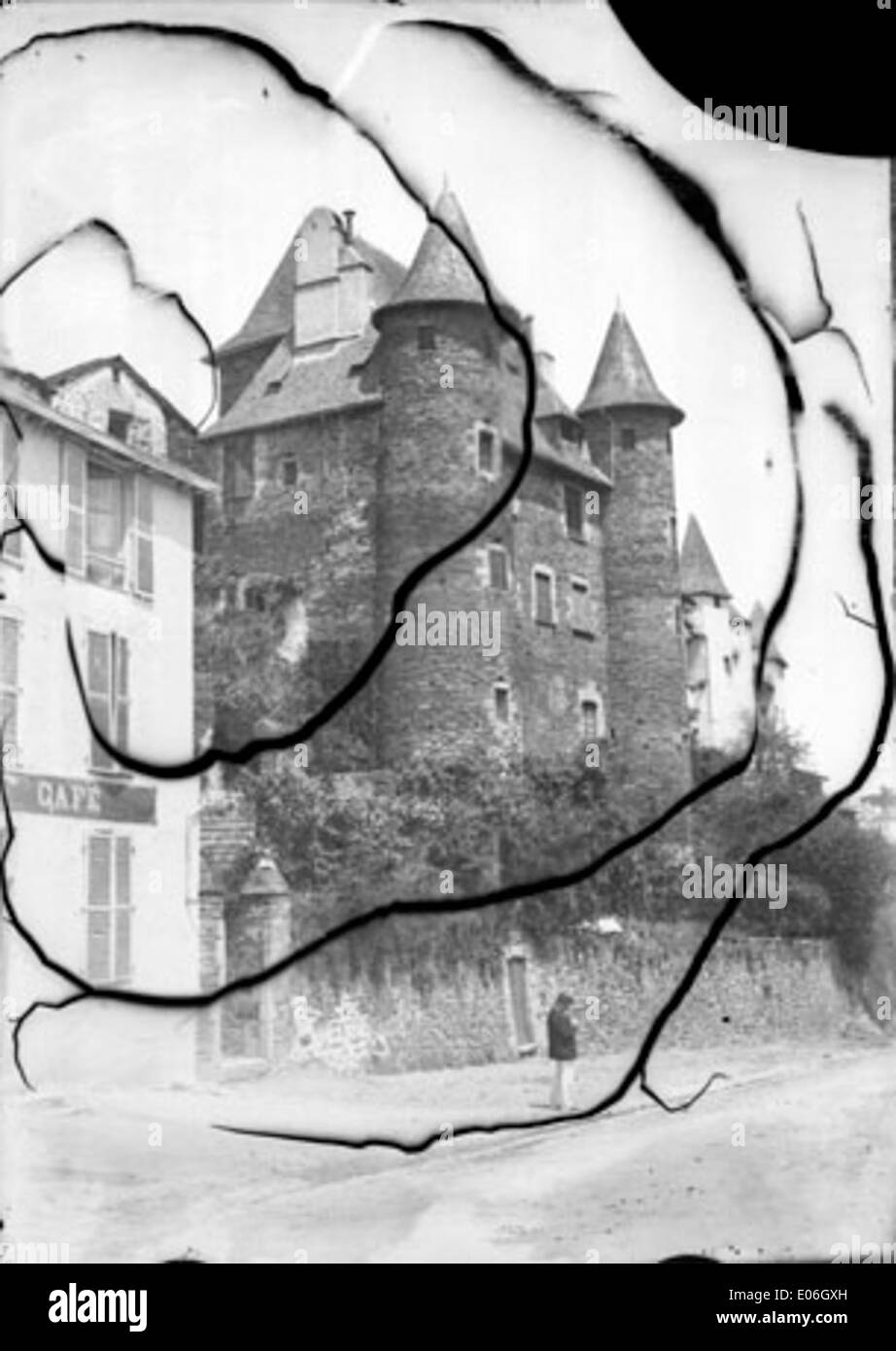 This photograph depicts a house with turrets in Uzerche, showcasing the ...