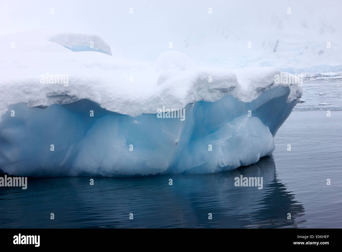 snow covered iceberg floating in the sea at Fournier Bay Antarctica ...