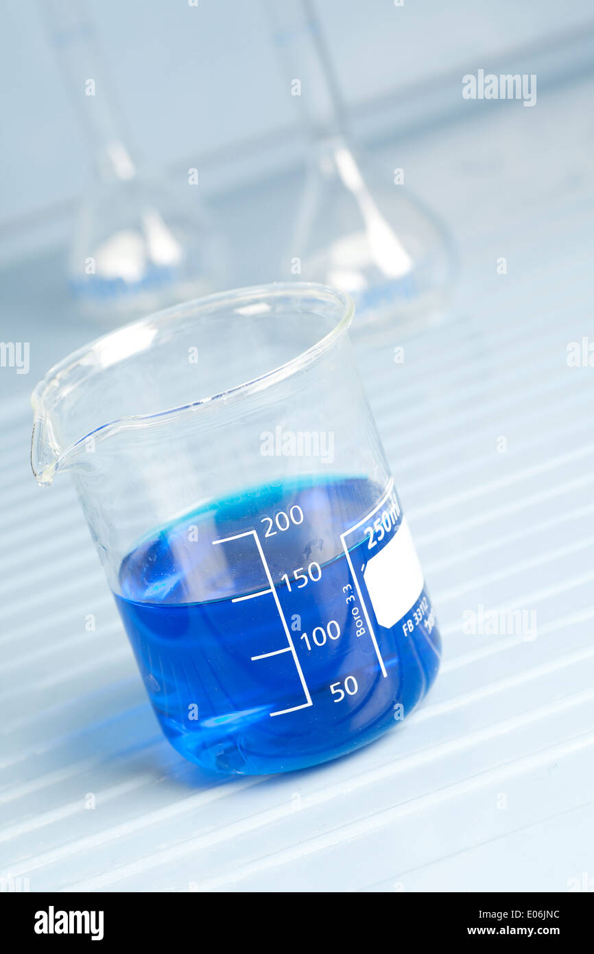Glass beaker in laboratory filled with blue solutions Stock Photo - Alamy