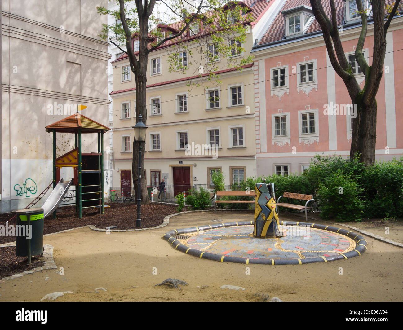 Open square with playground, benches and trees for relaxing ...