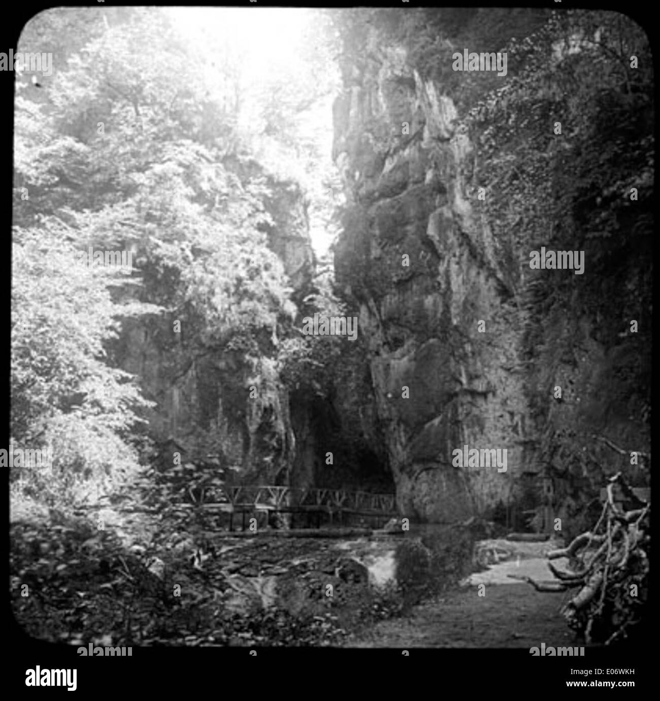 A wooden bridge spanning between two rocks at a mountain peak ...