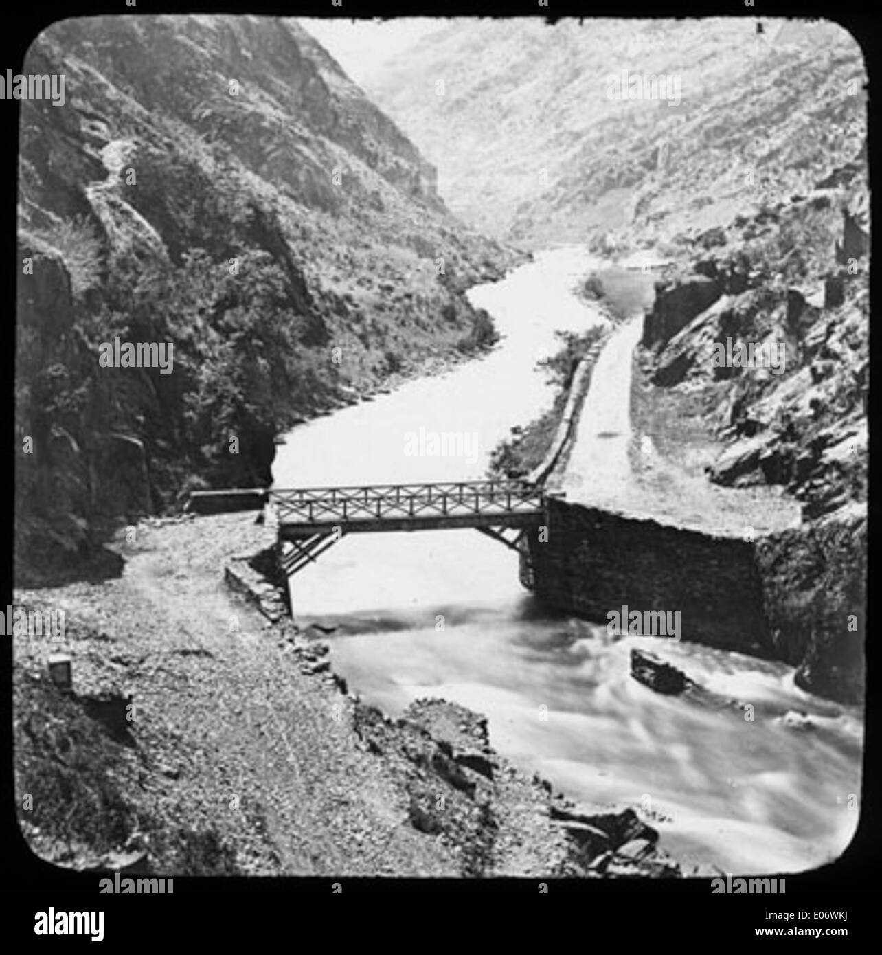 A photograph showing an iron bridge in a narrow valley, capturing the ...