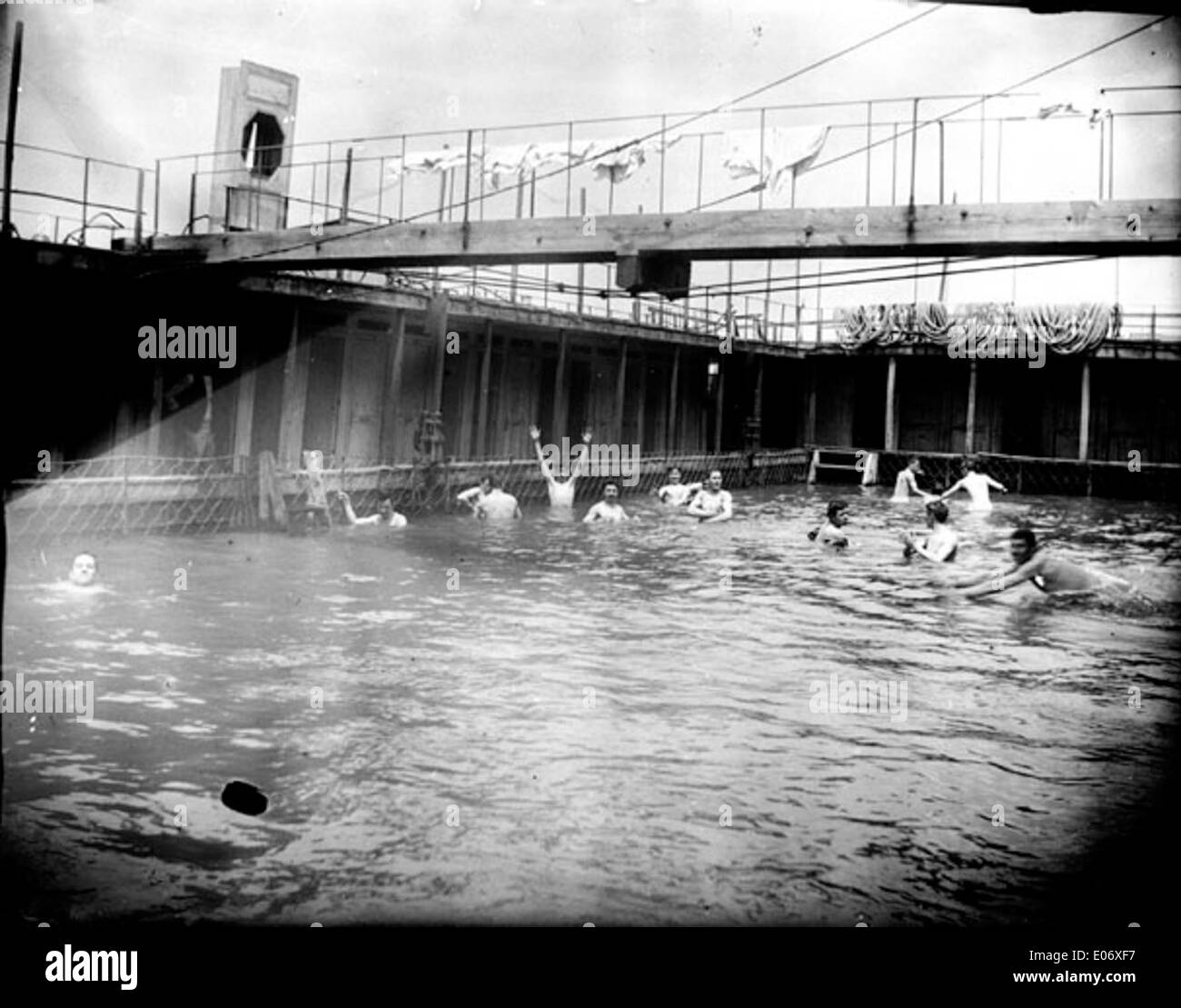 A vintage photograph featuring a pool with swimmers, capturing the ...