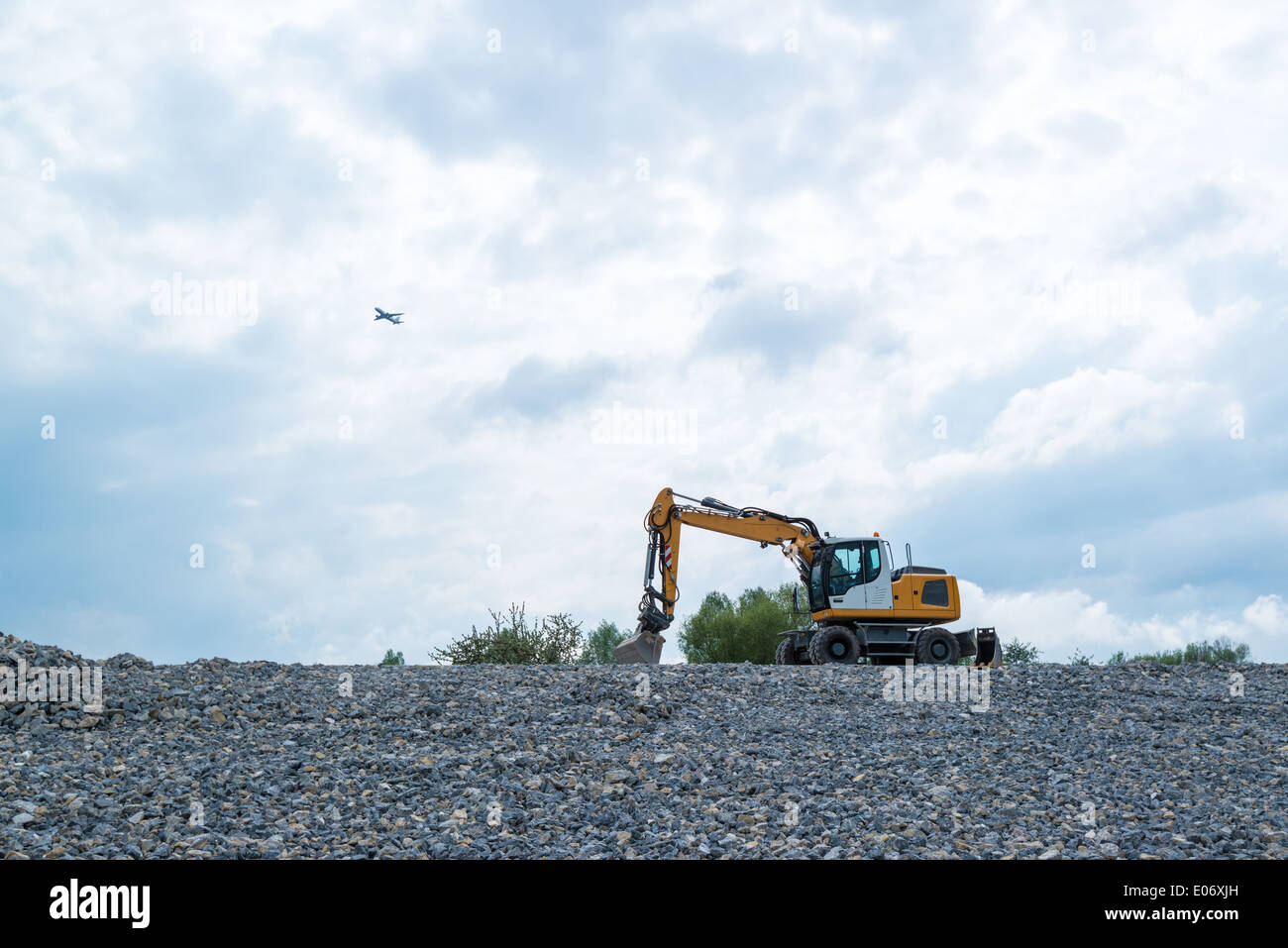Image of a wheeled excavator on a quarry tip with extra shovel and ...