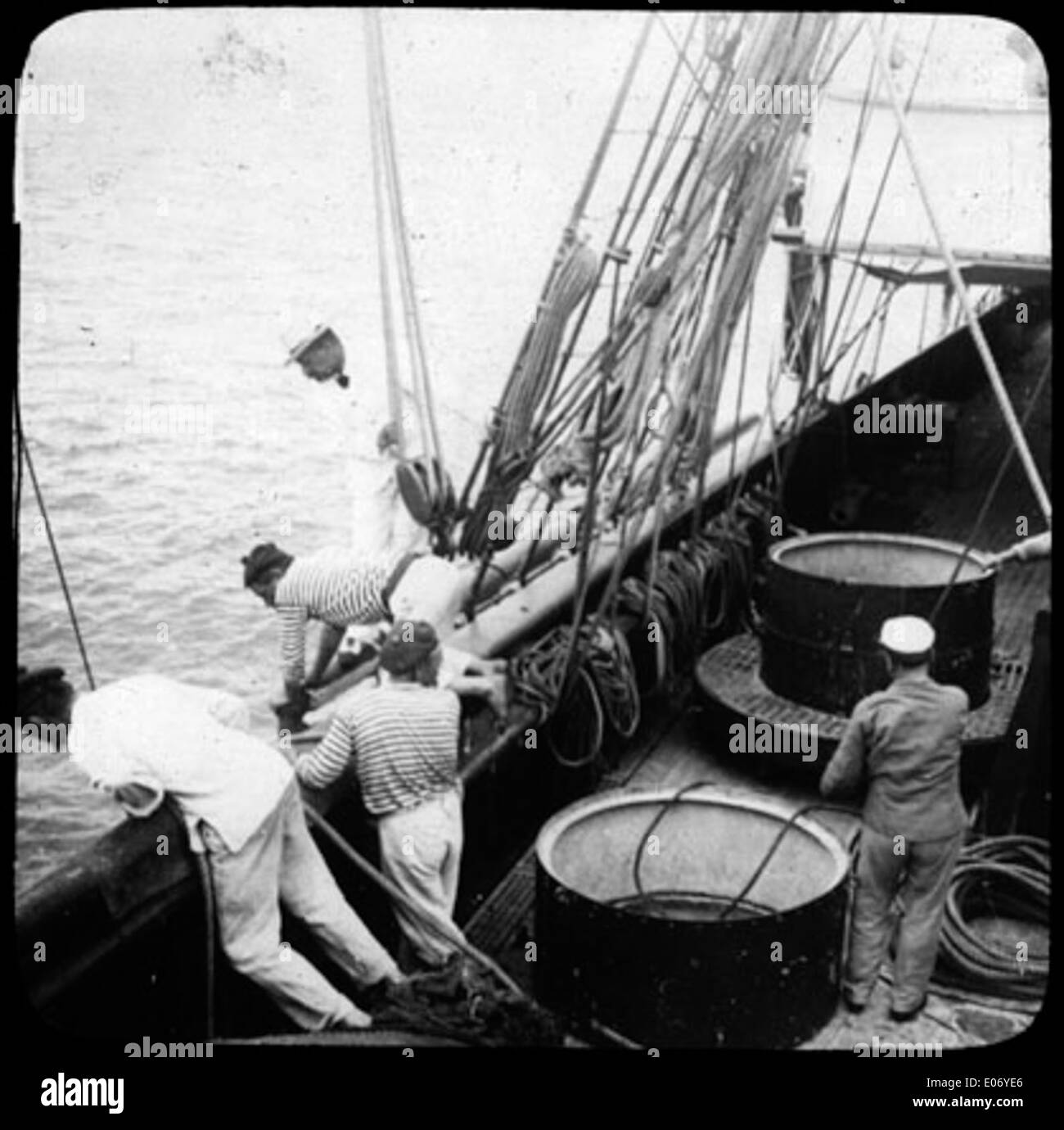 A photograph from 1905 showing fishermen working near the boat ...